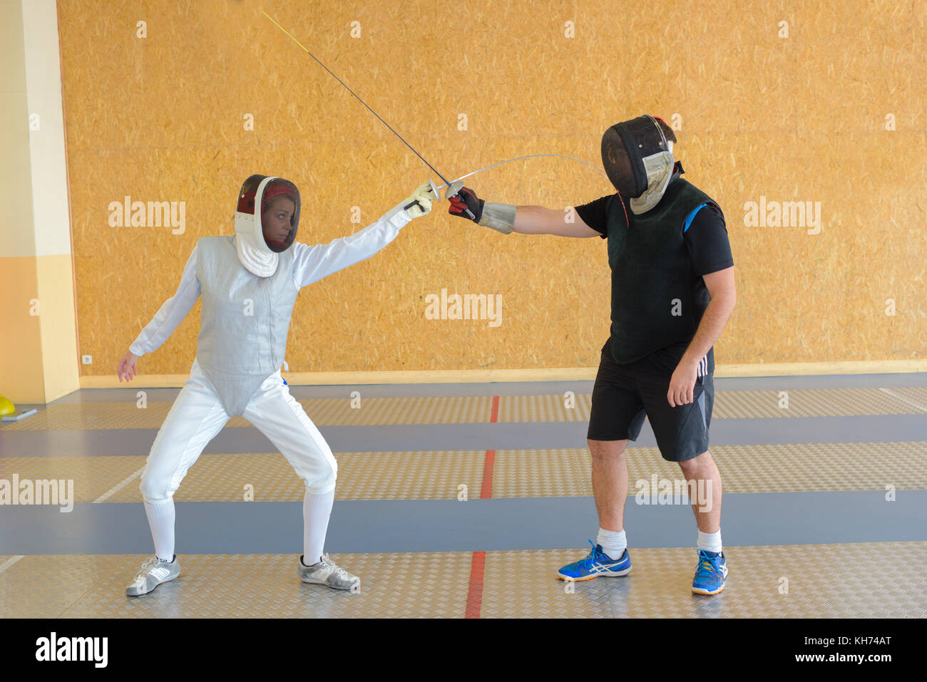 People fencing indoors Stock Photo - Alamy