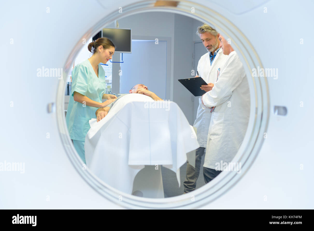 Hospital scene viewed through round window in door Stock Photo - Alamy