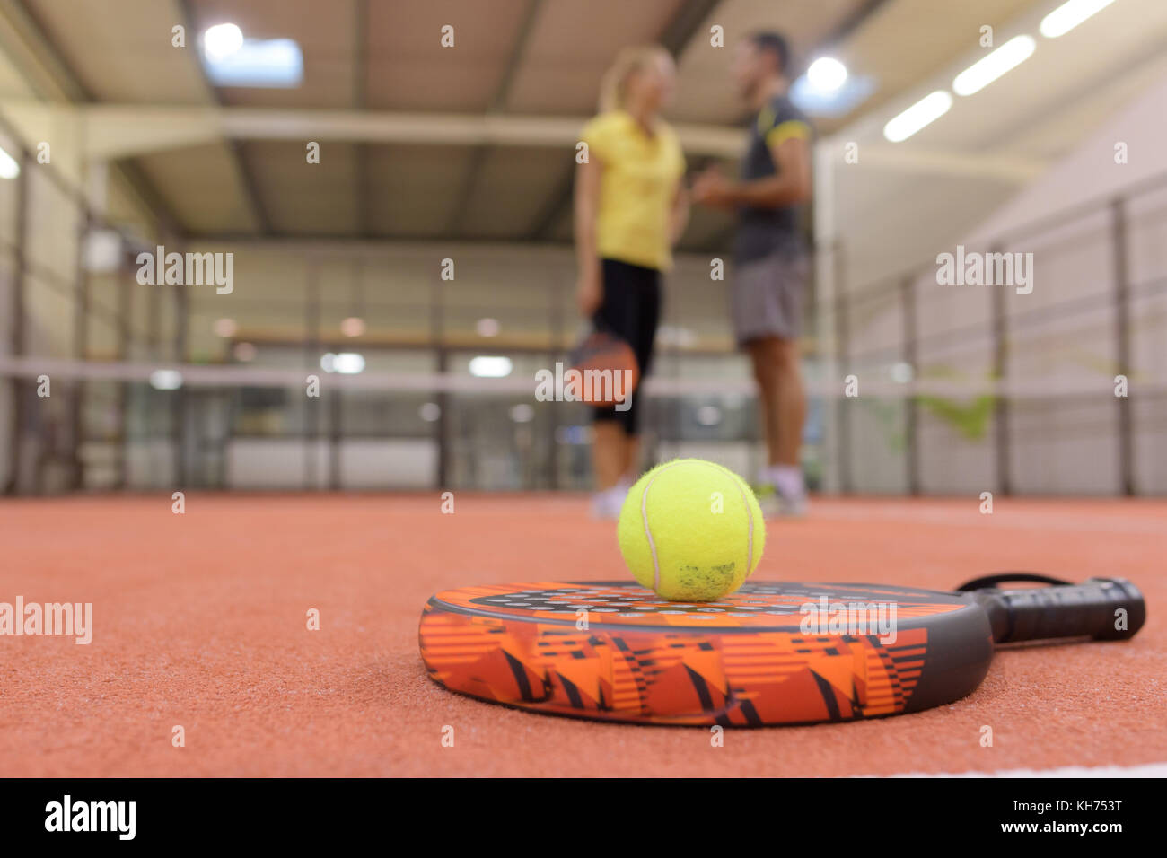 tennis racket and two balls near net on indoor court Stock Photo - Alamy