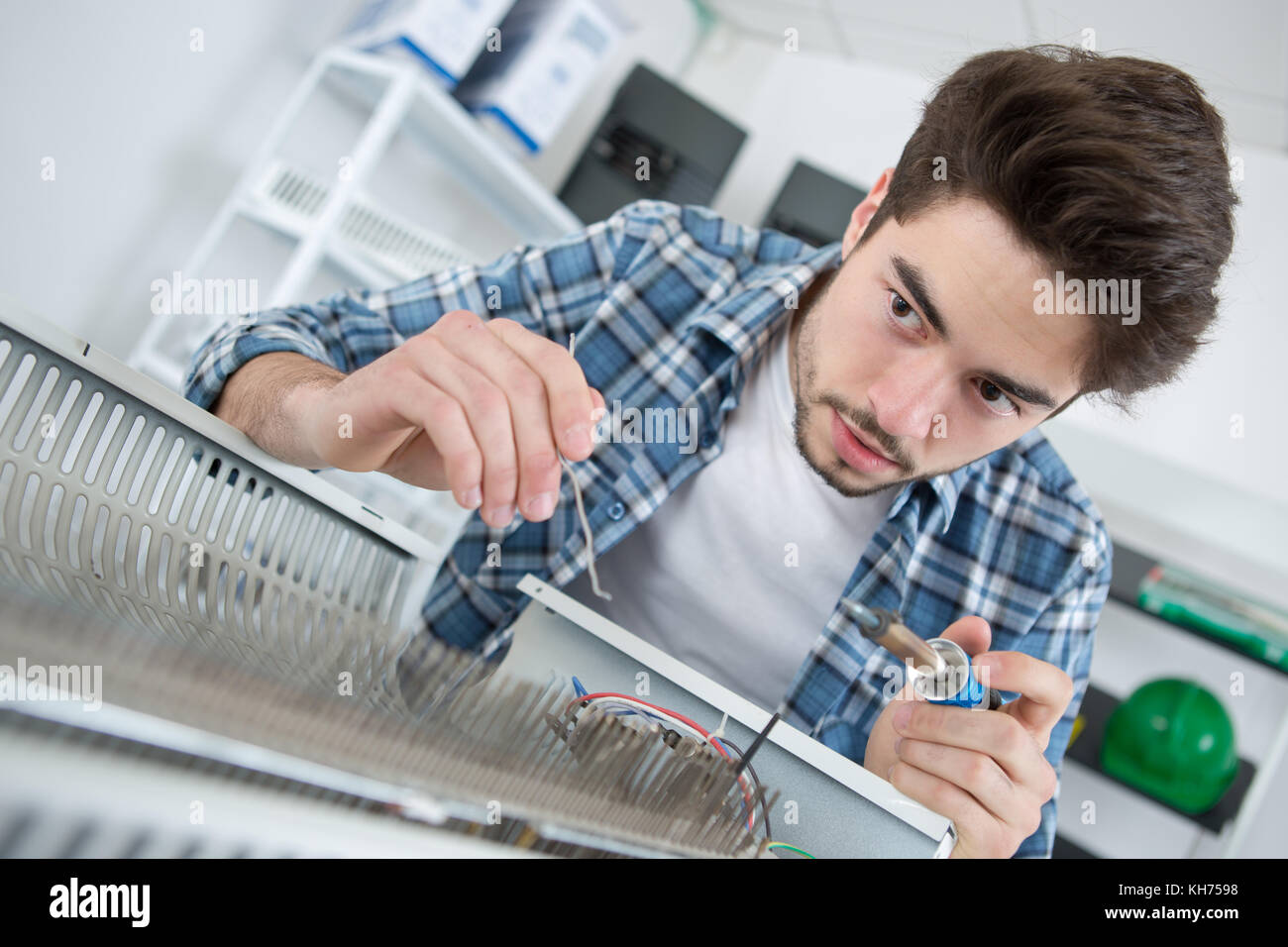 young man adjustment of heating radiator Stock Photo - Alamy