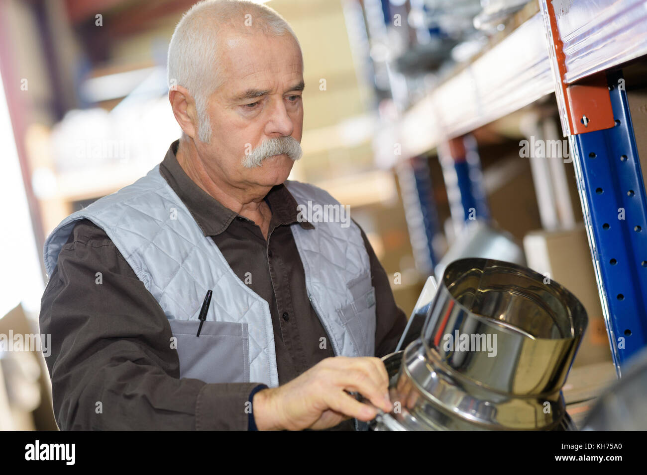 senior checking a metal process in factory Stock Photo - Alamy
