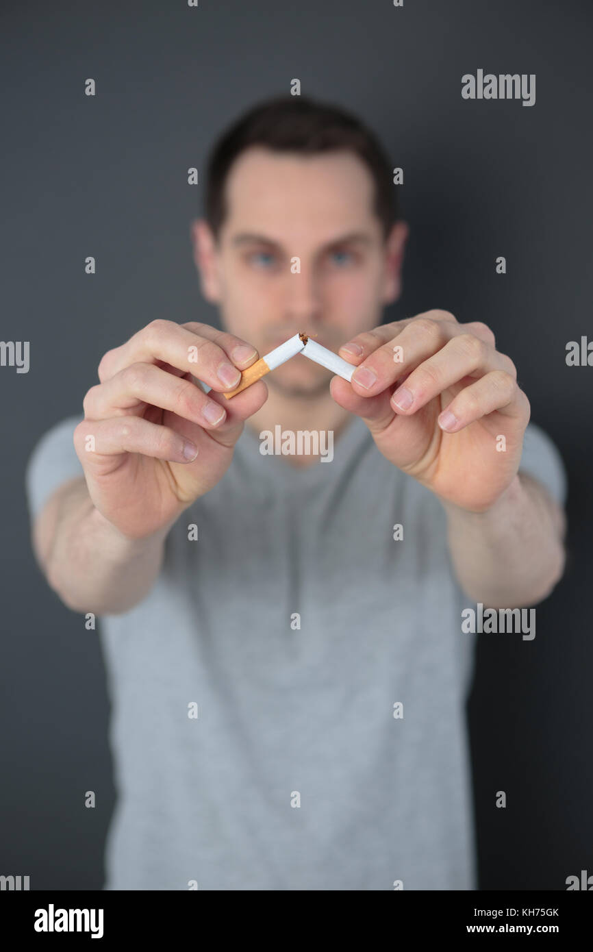 adult man breaking cigarette Stock Photo - Alamy