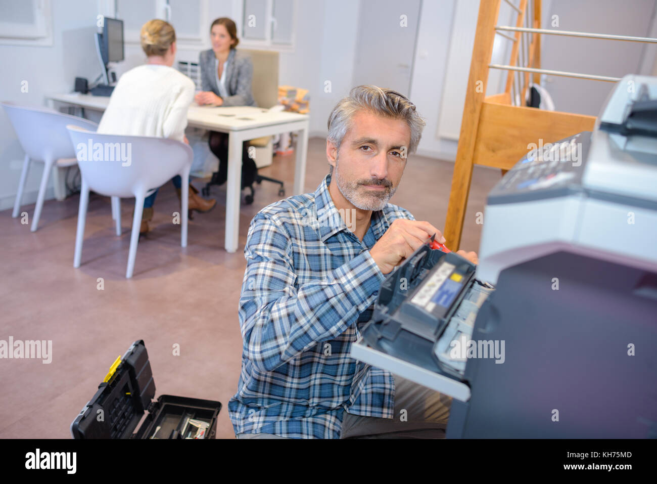 Man repairing office photocopier Stock Photo - Alamy