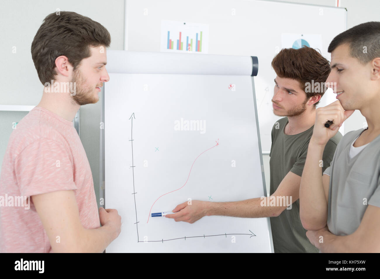 group of students presenting and discussing project in classroom Stock ...