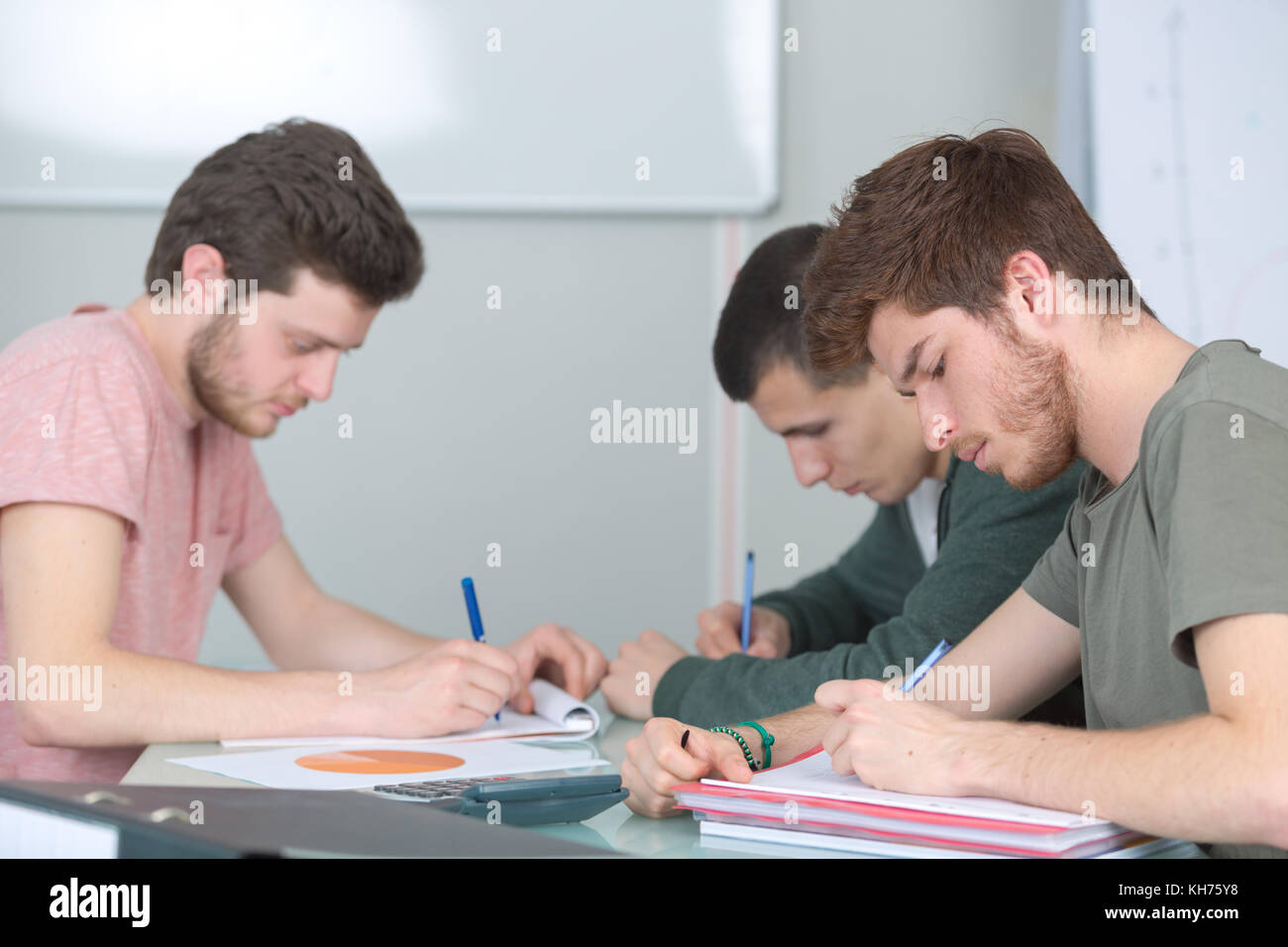 3 male young students studying together Stock Photo - Alamy