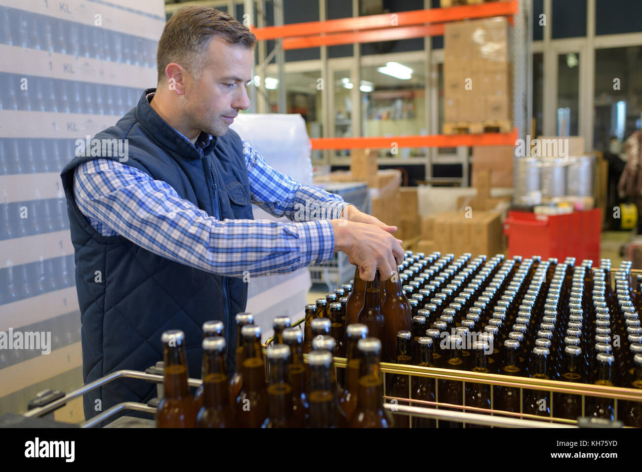 brewery worker arranging the bottles Stock Photo - Alamy