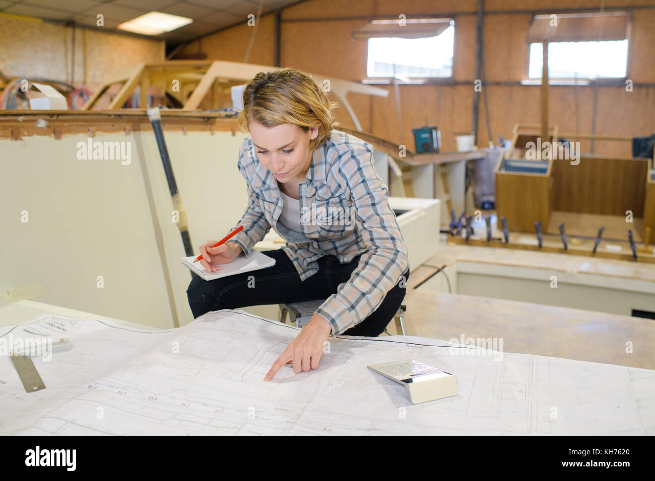 woman studying the blueprint of the boat Stock Photo - Alamy