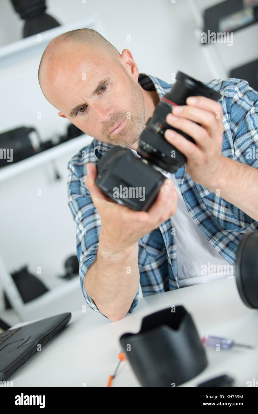 Technician fitting camera components together Stock Photo - Alamy