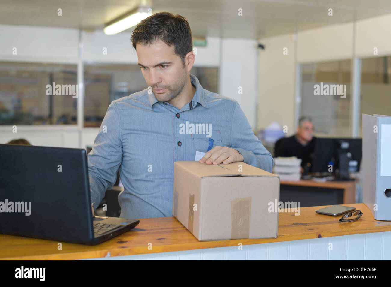 man on the office receiving a delivery Stock Photo - Alamy