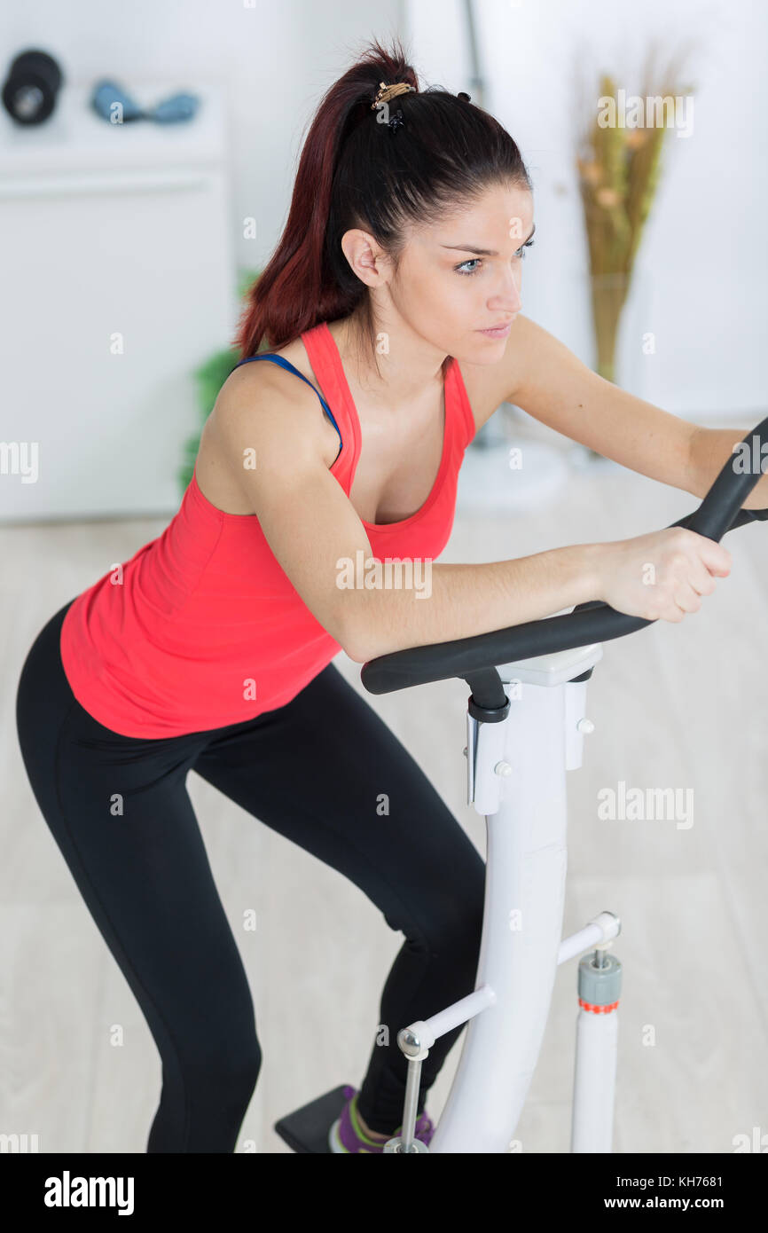 Woman exercising on step machine Stock Photo - Alamy