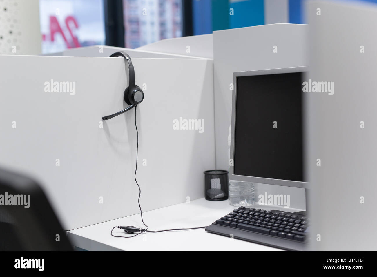 Computer and headset in empty call center office Stock Photo - Alamy