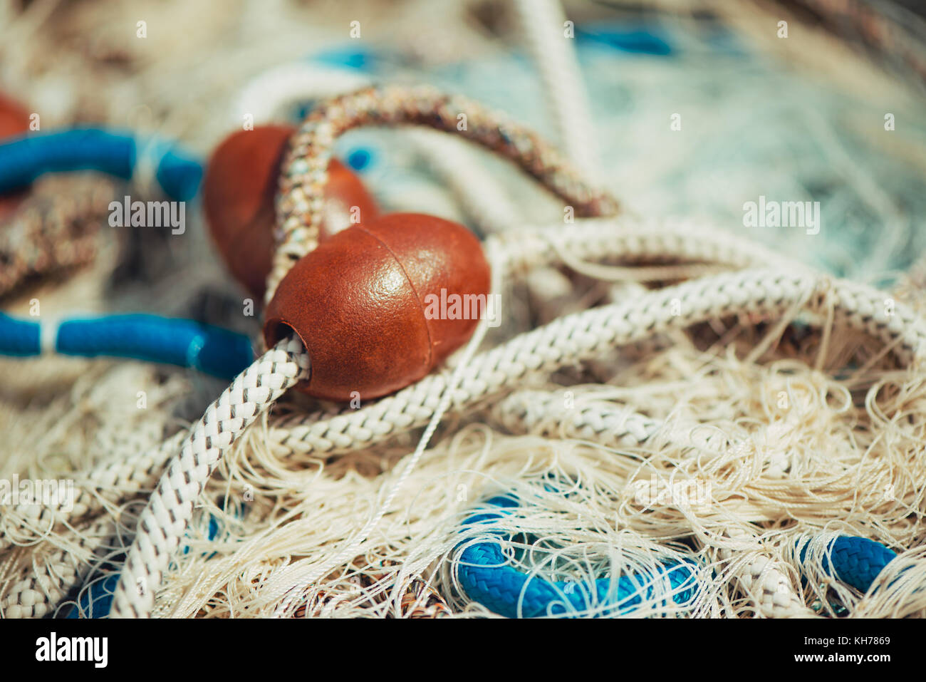 Pile of commercial fishing net with cords and floats as abstract ...