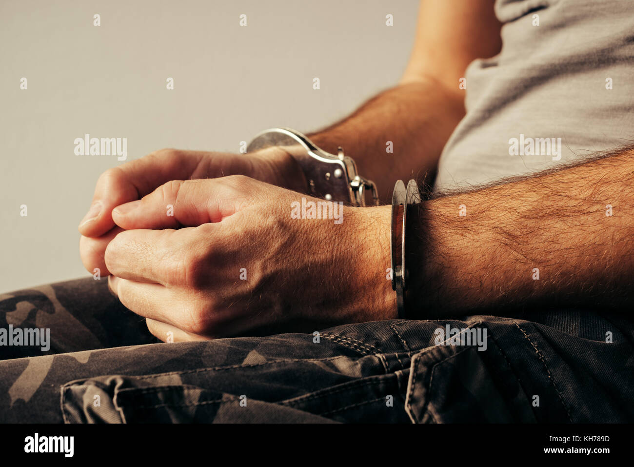 Handcuffed soldier in military army clothes. Prisoner of war or ...