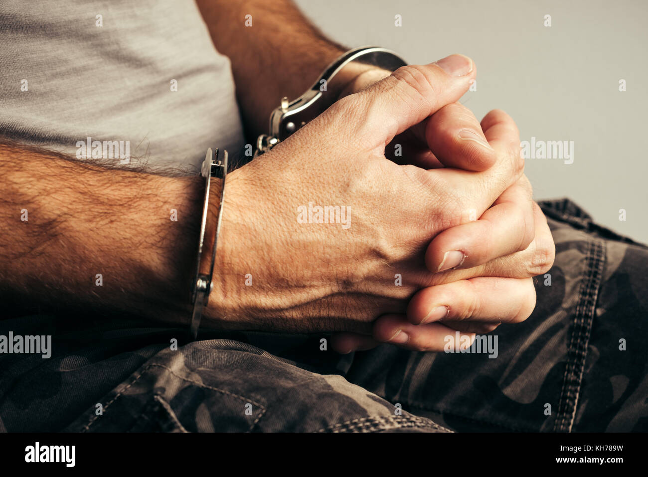 Handcuffed soldier in military army clothes. Prisoner of war or ...