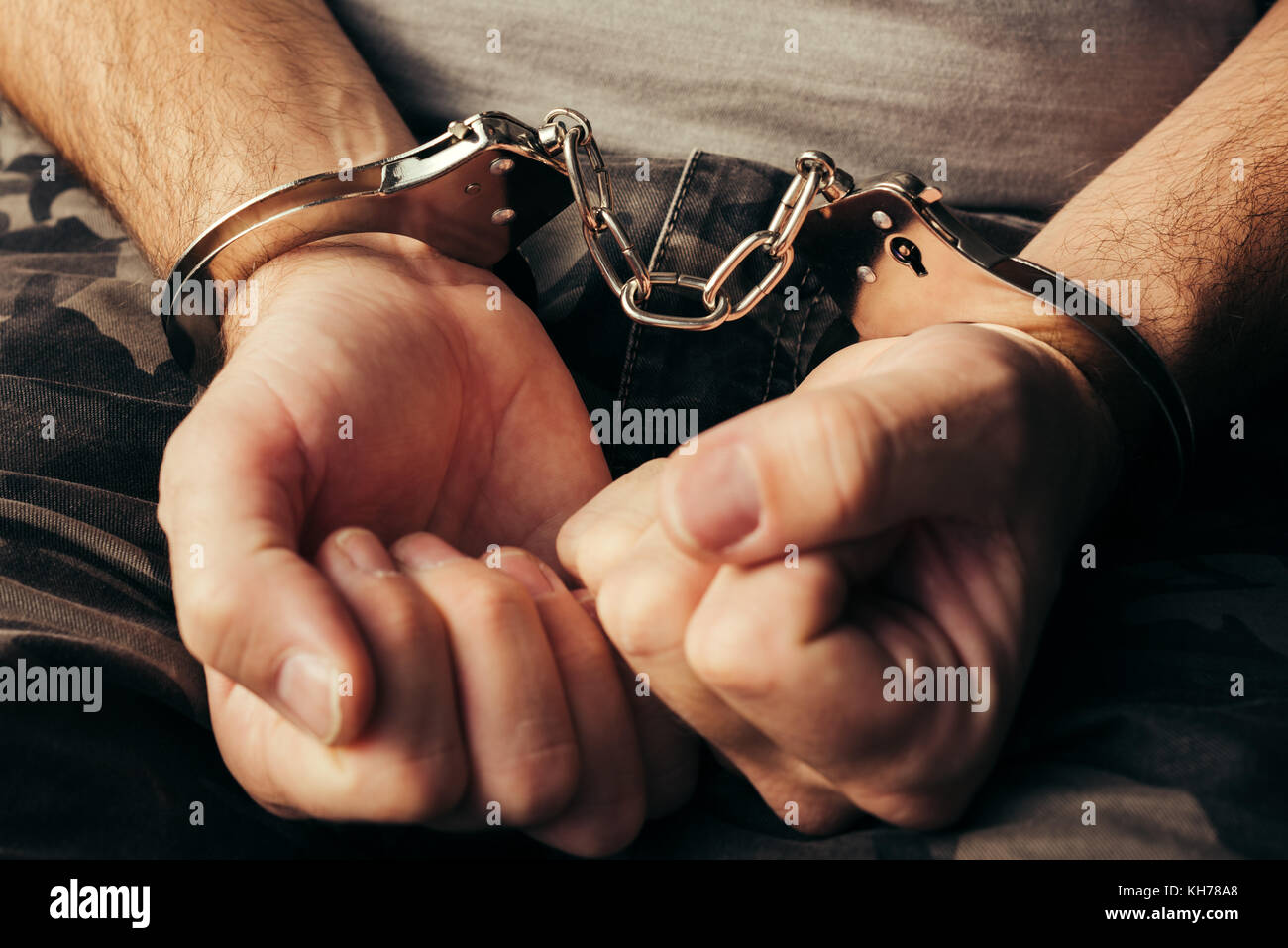 Handcuffed soldier in military army clothes. Prisoner of war or ...