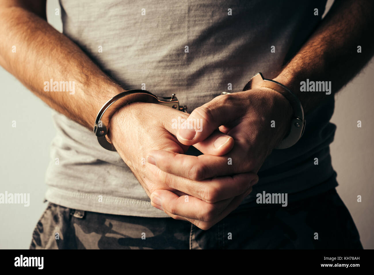 Handcuffed soldier in military army clothes. Prisoner of war or ...
