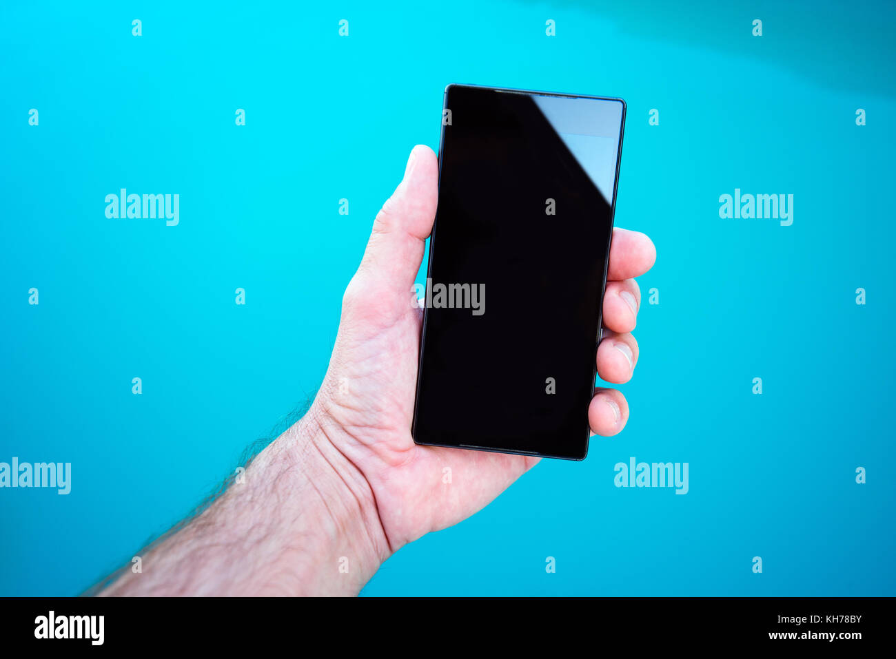 Using mobile phone by the swimming pool, male hand holding smartphone ...