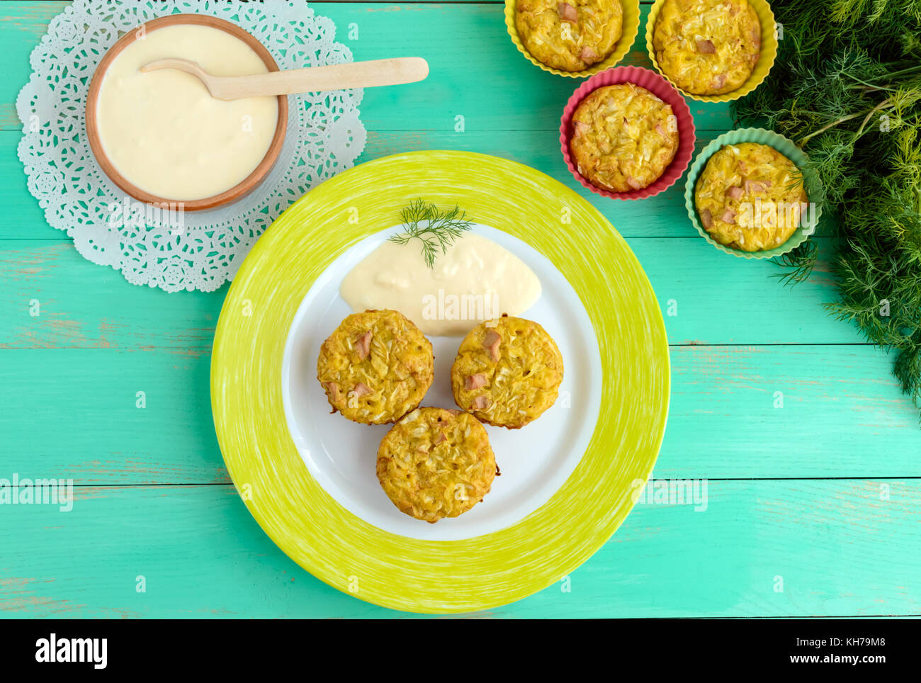 Muffins from cabbage with ham and cheese. Sour cream sauce. The top ...