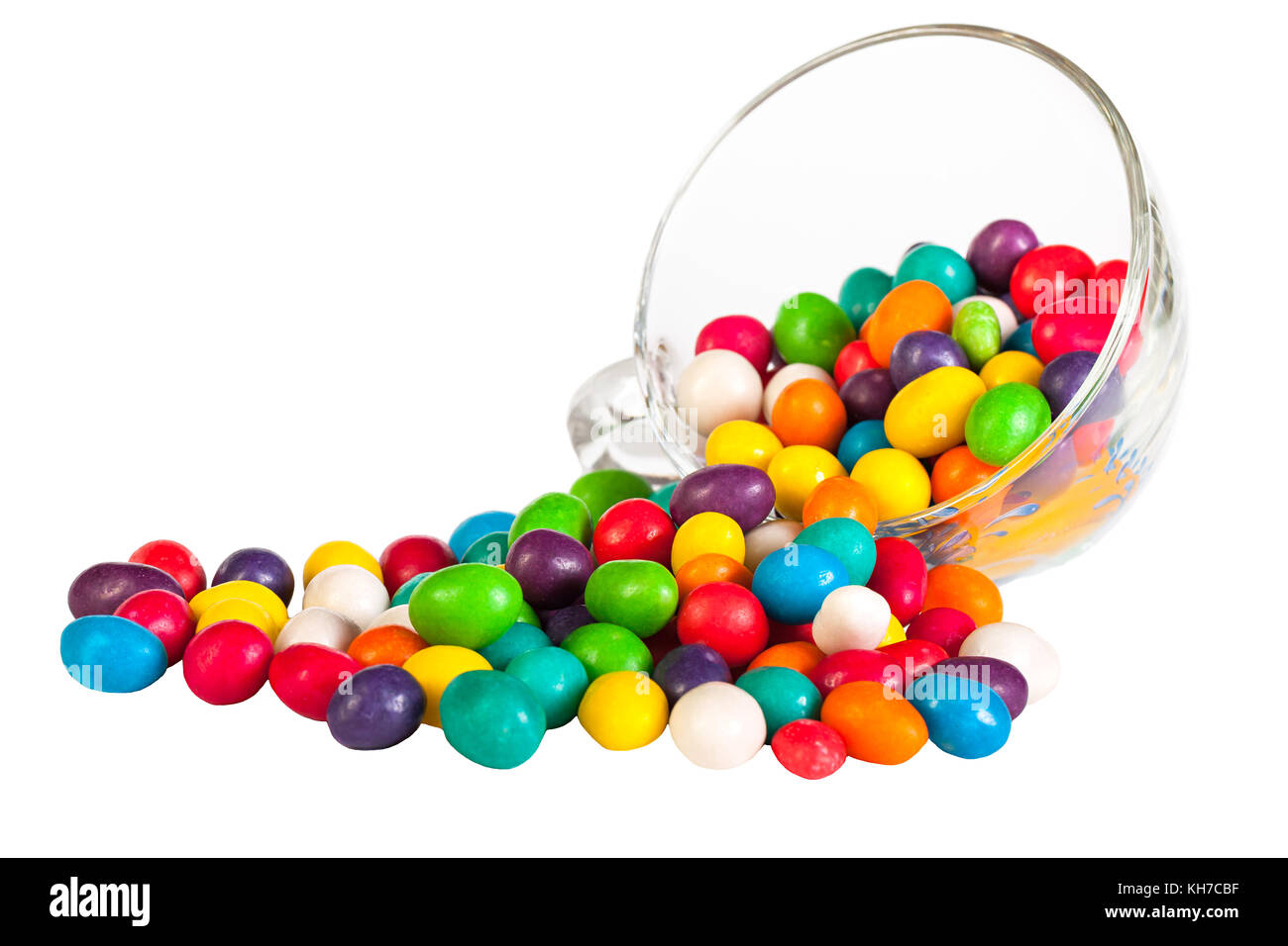 colorful sprinkle candies in a glass isolated on a white background ...