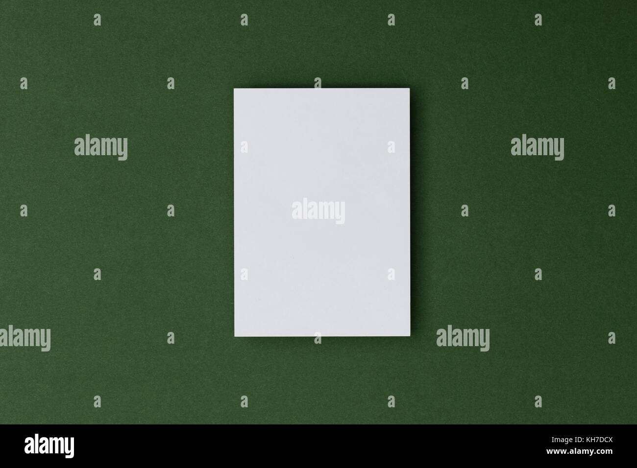 Blank white postcard on a green background Stock Photo - Alamy