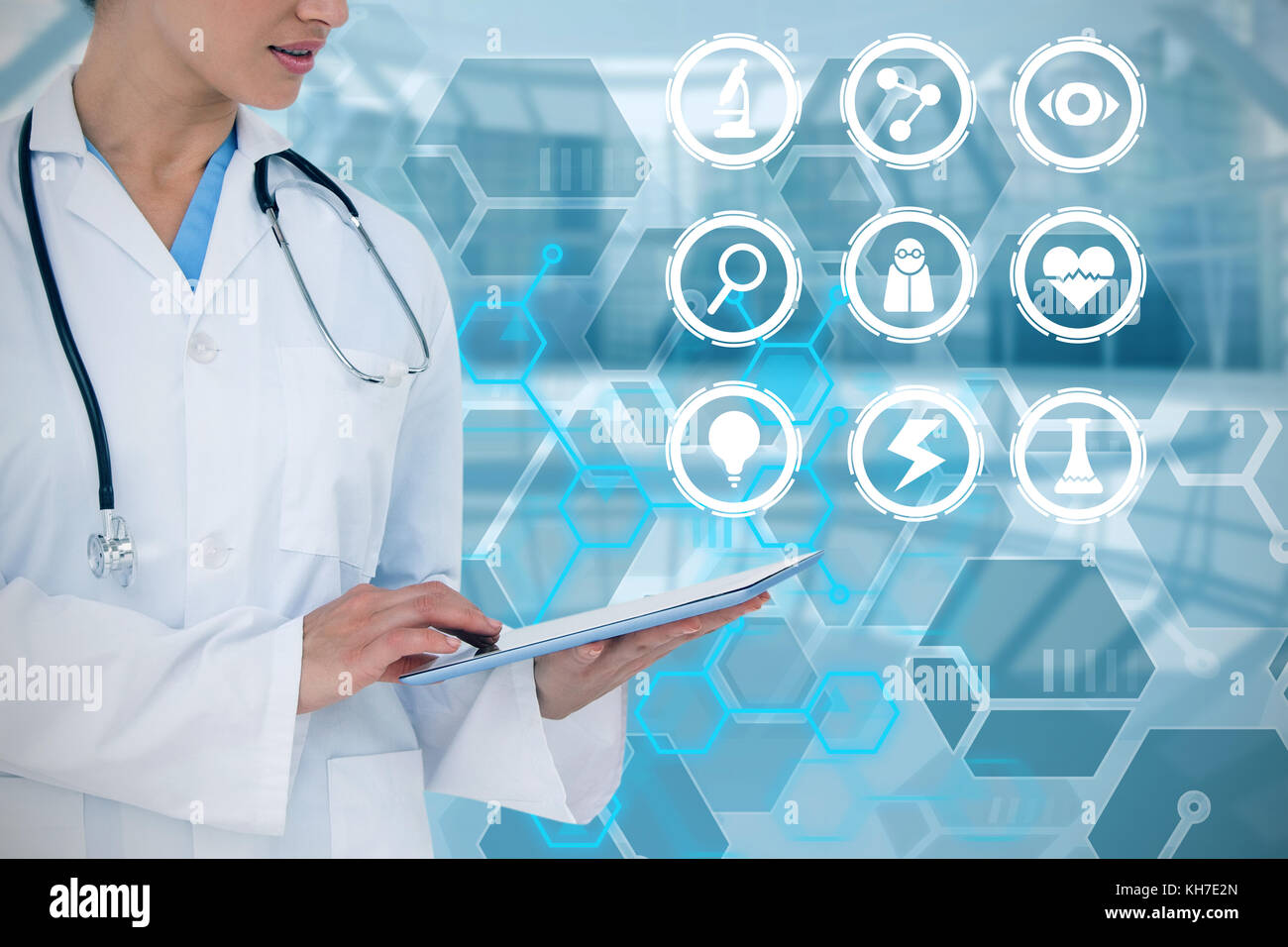 Happy doctor using her tablet pc against computer graphic image of ...