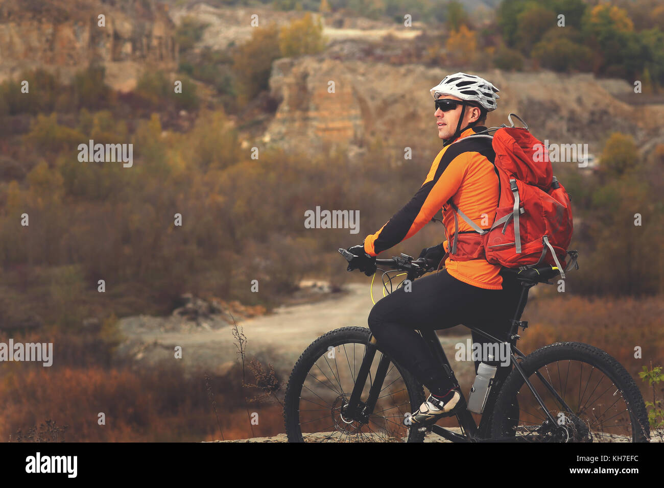 Traveler with backpack Riding the Bike on the Beautiful Spring Mountain ...