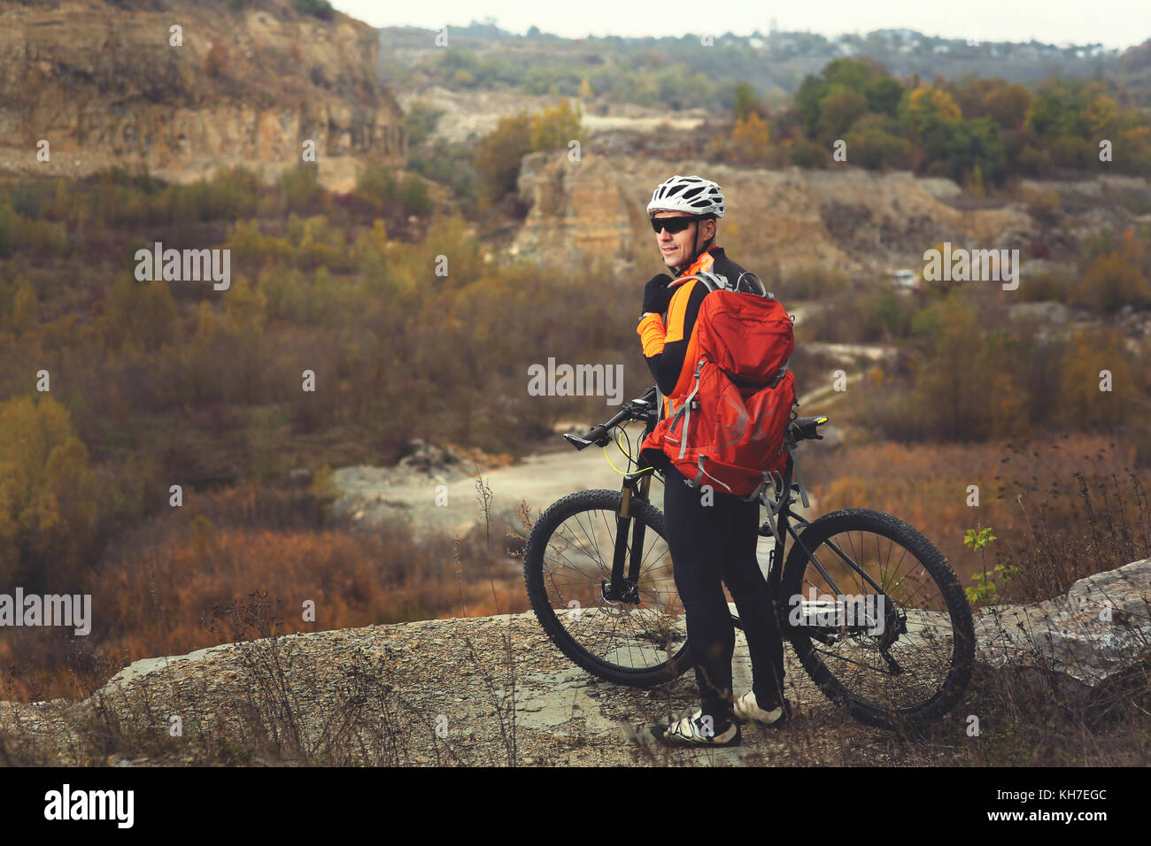 Traveler with backpack Riding the Bike on the Beautiful Spring Mountain ...