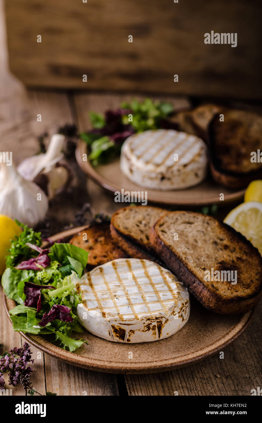 Grilled camembert cheese, mini salad and baked bread Stock Photo - Alamy