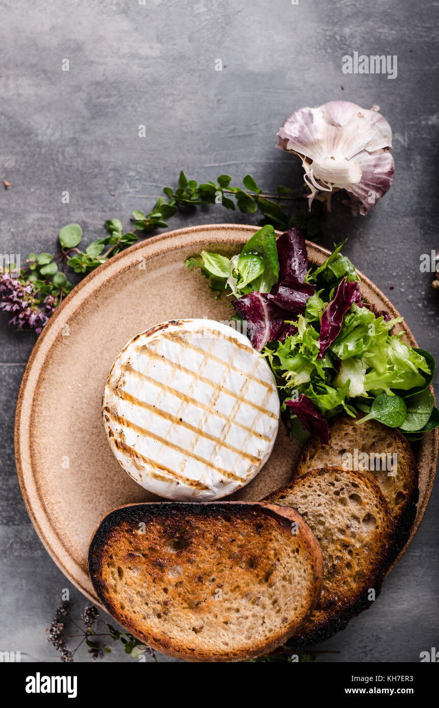Grilled camembert cheese, mini salad and baked bread Stock Photo - Alamy