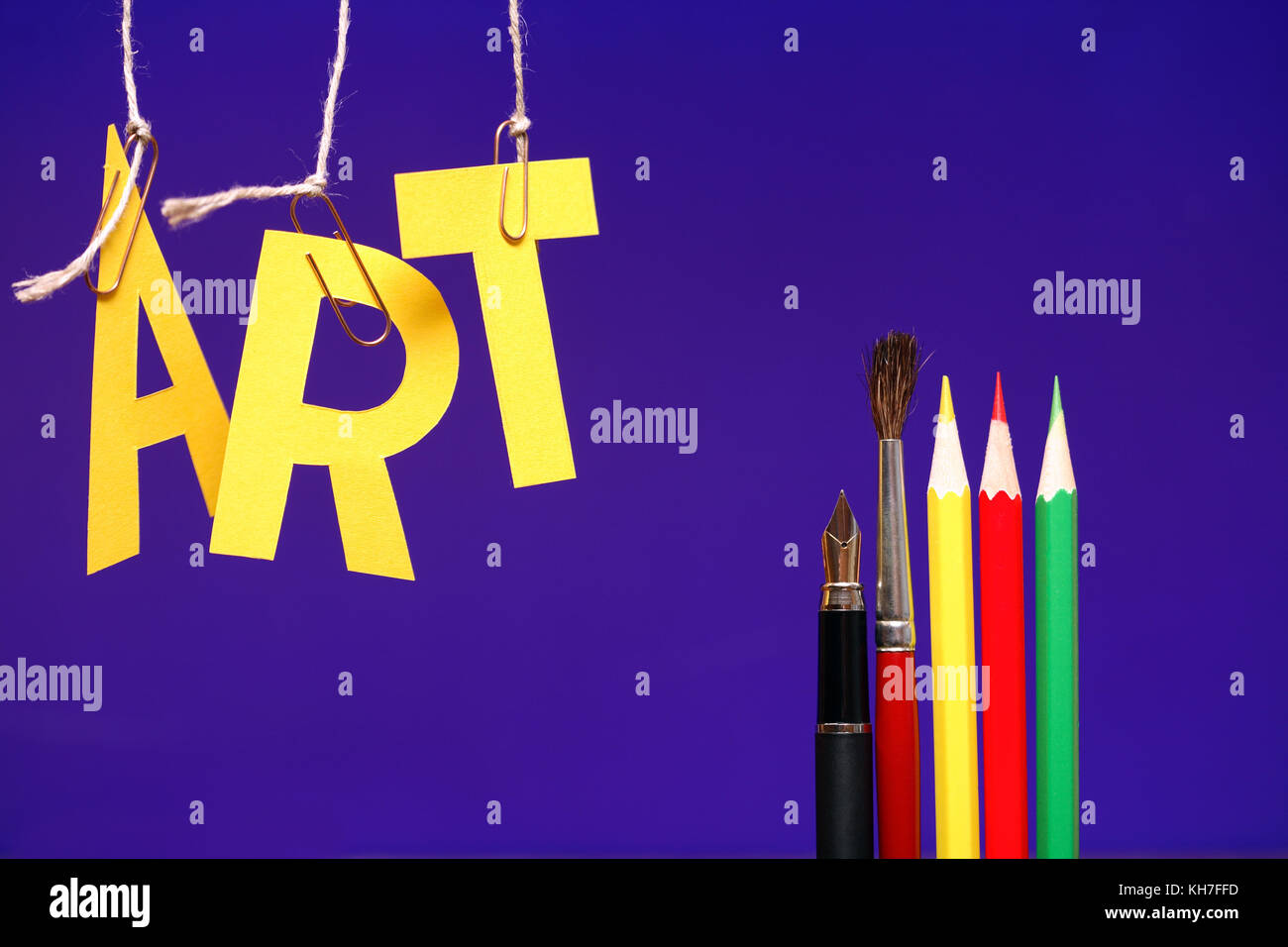 Word ART made from yellow paper hanging with rope on blue background ...