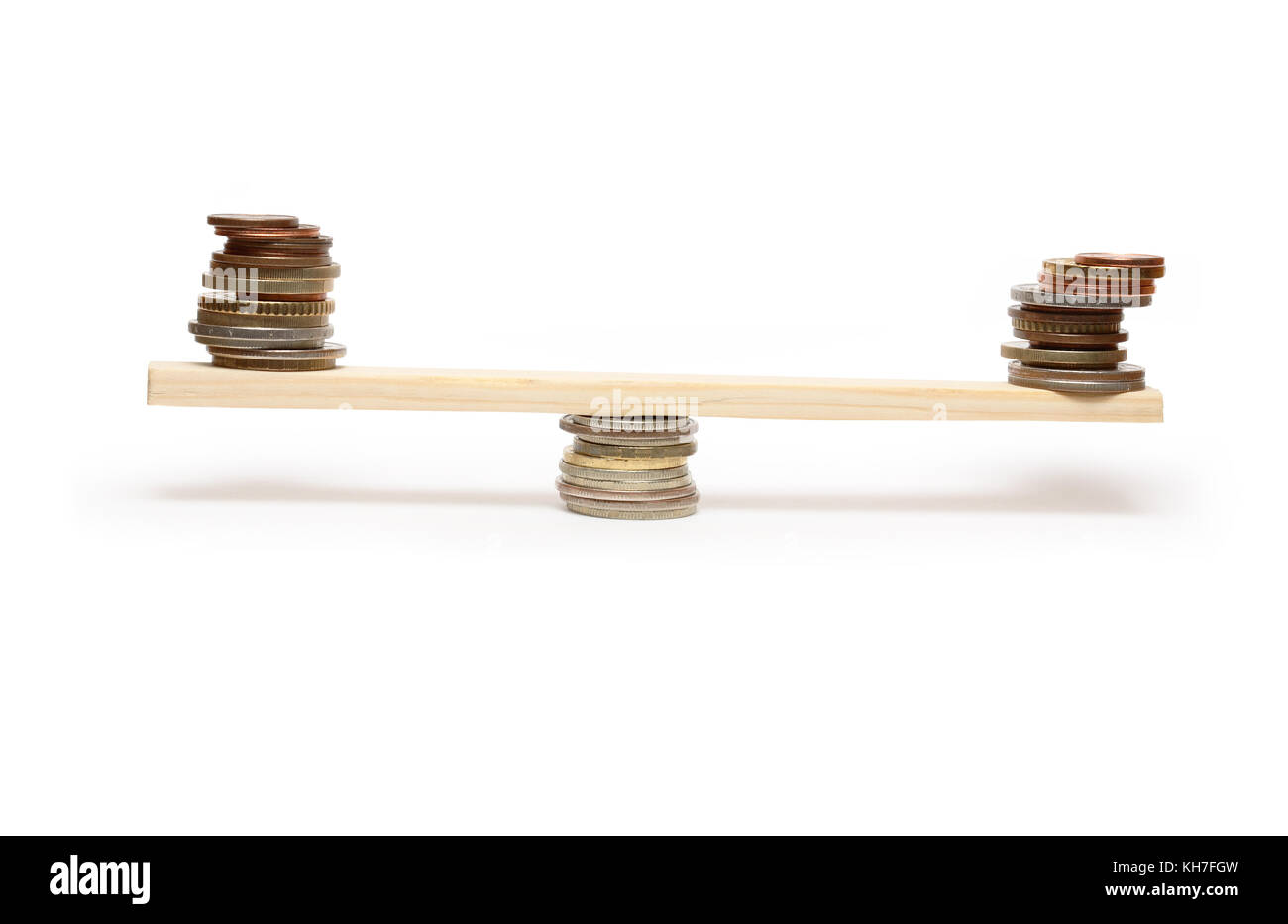 Coins lying on seesaw isolated on white background with clipping path ...