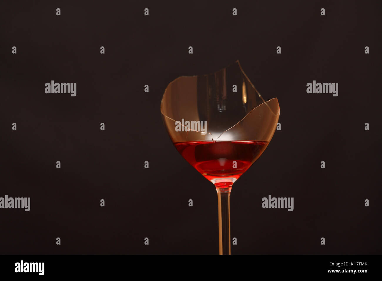 Broken wineglass with red wine on dark background Stock Photo - Alamy