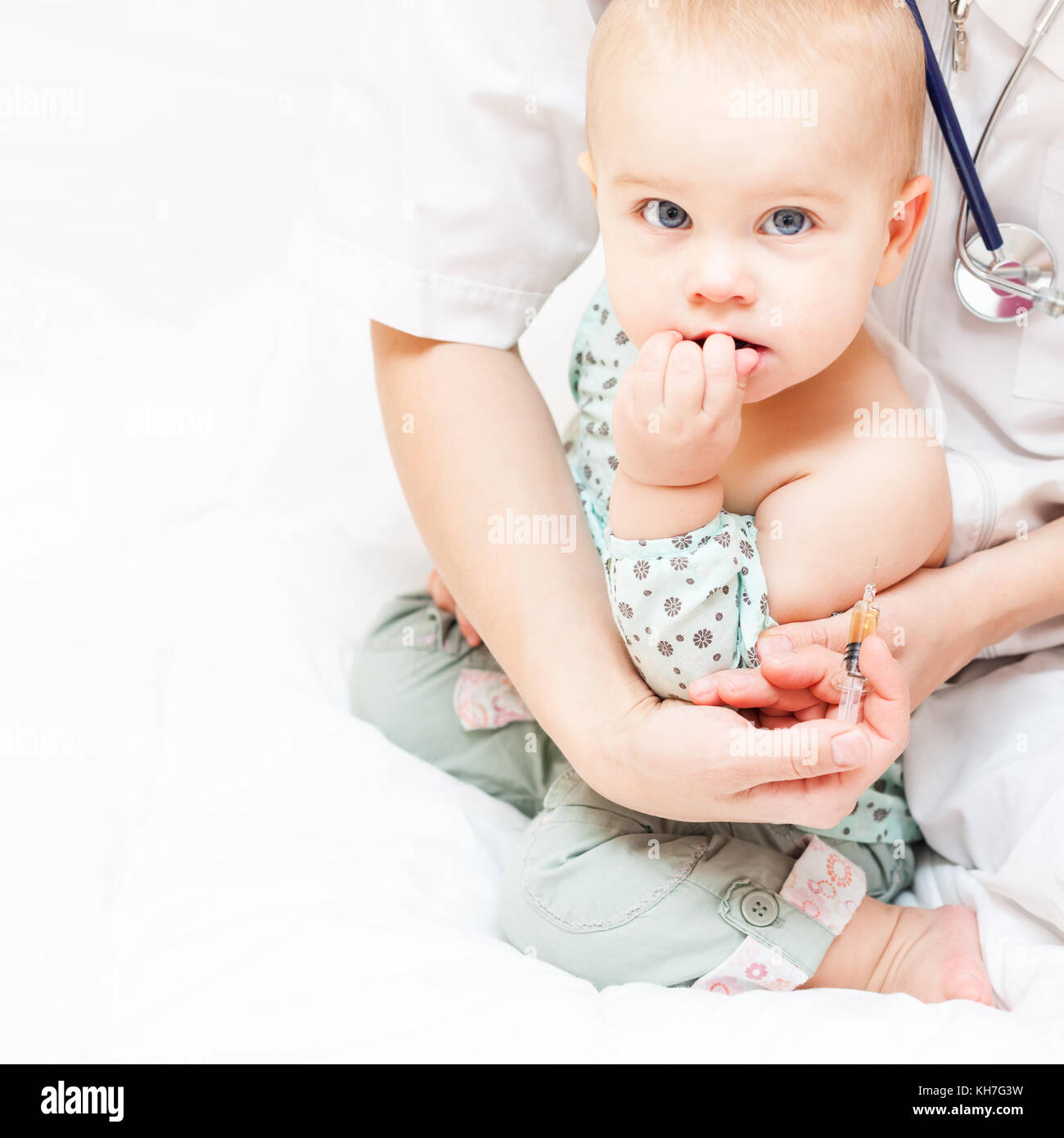 Close-up shot of pediatrician ready to give an intramuscular injection ...