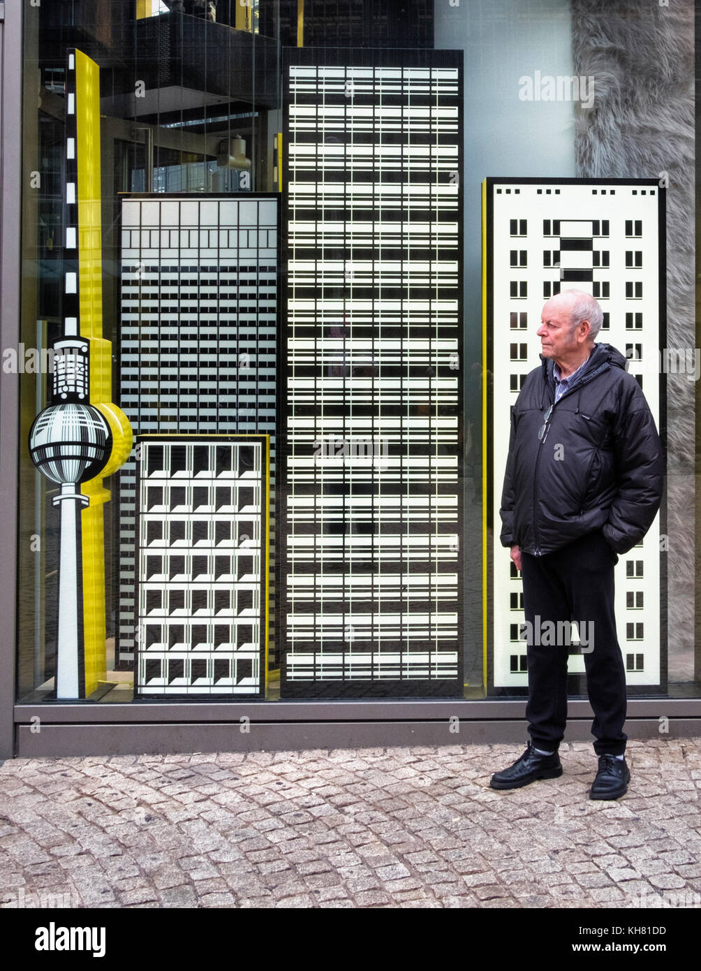 Germany, Berlin,Friedrichstrasse.Elderly male standing next to graphic ...