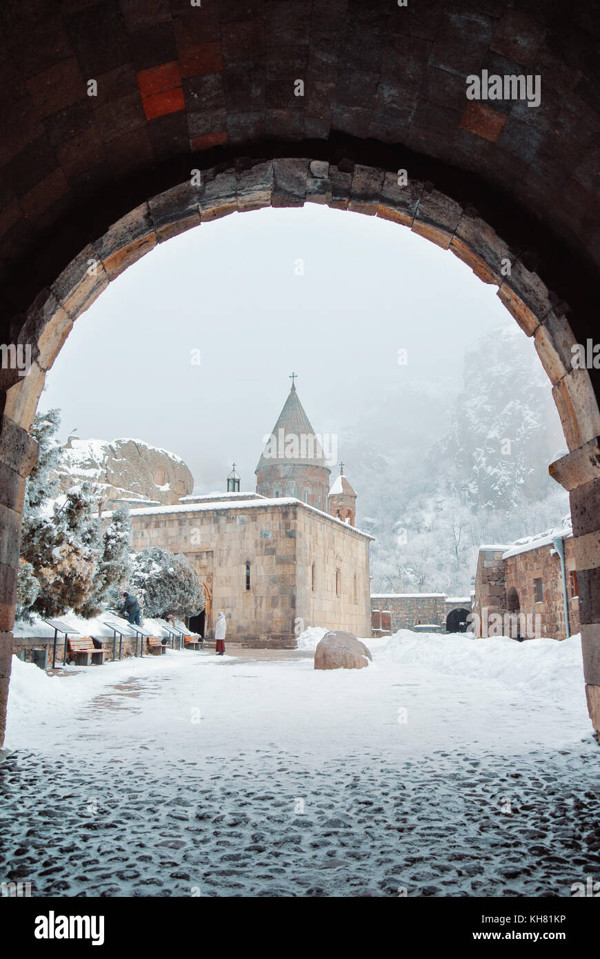 Armenian monastery Geghard, a view through an tuff arch entrance to a ...