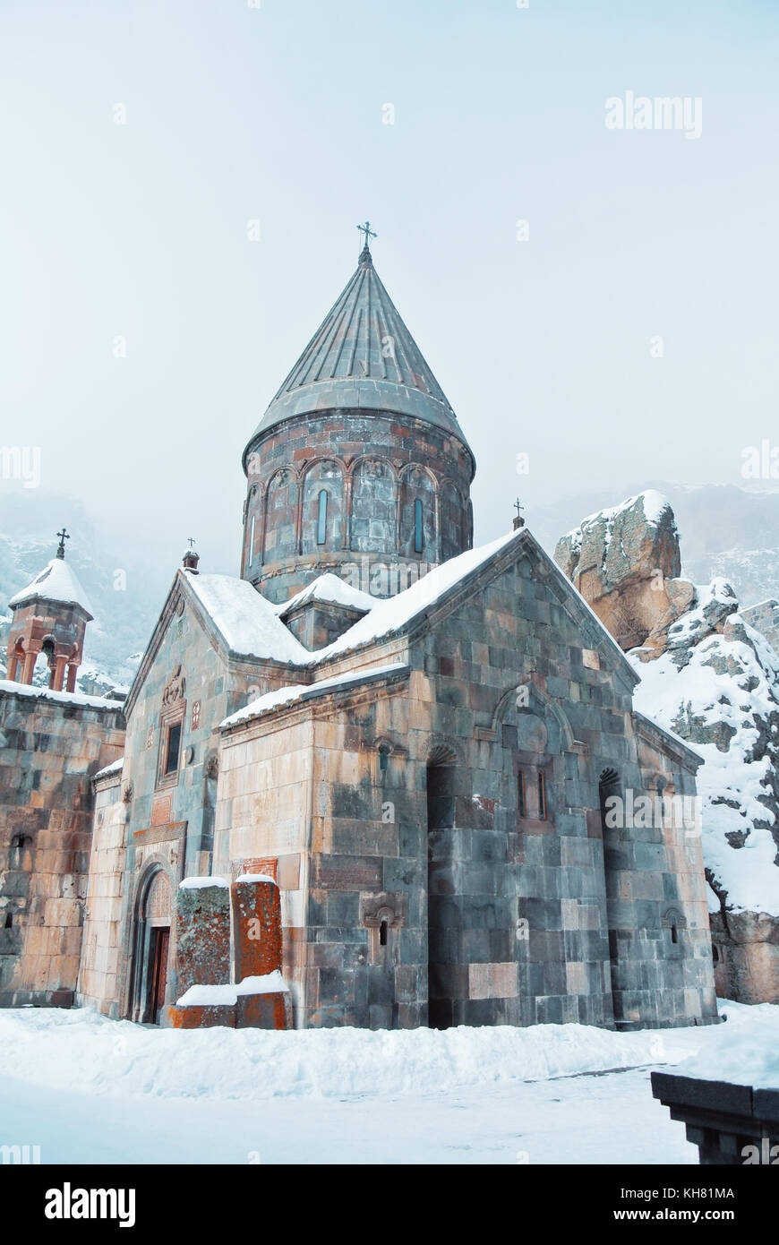 Armenian monastery Geghard, a church yard, pavement and trees covered ...
