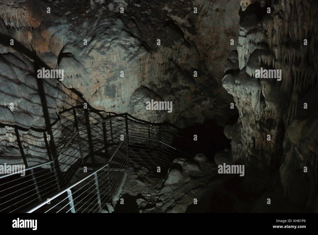 Staircase going deep into the cave, beautiful illuminated formations ...