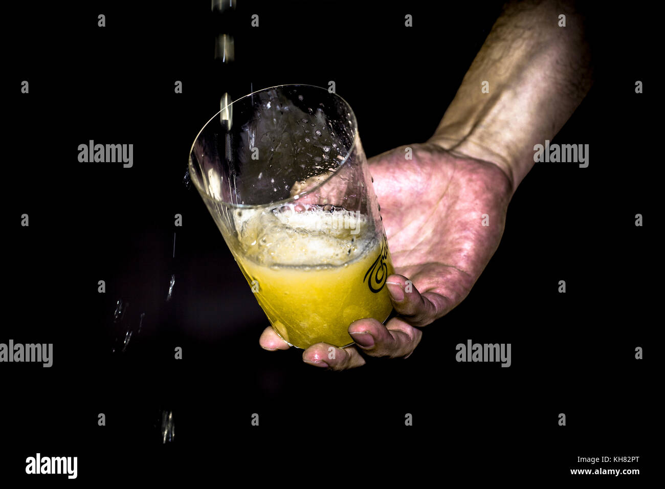 young spanish man pouring out asturian cider Stock Photo - Alamy