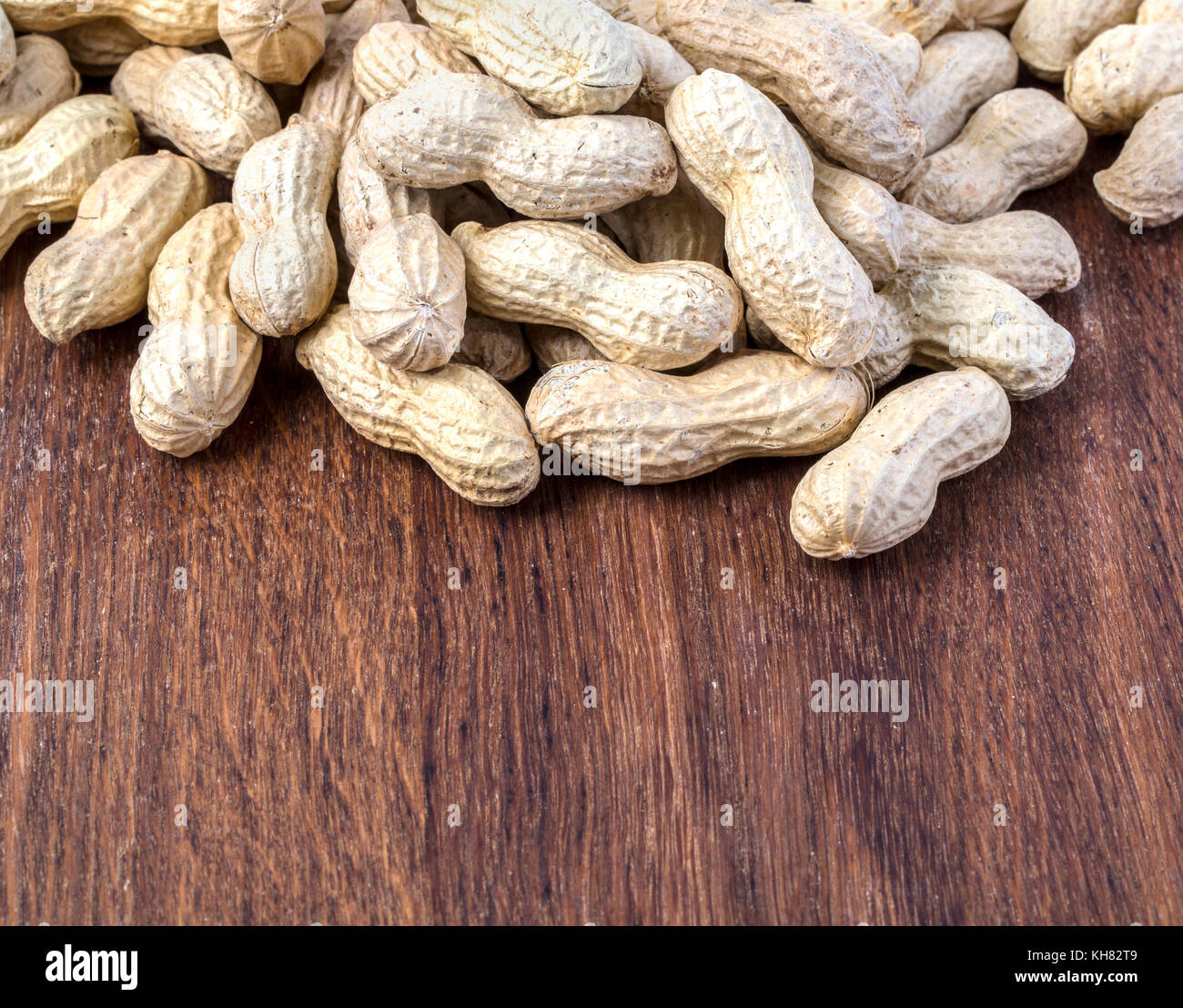 peanuts on wooden bacground close up Stock Photo - Alamy