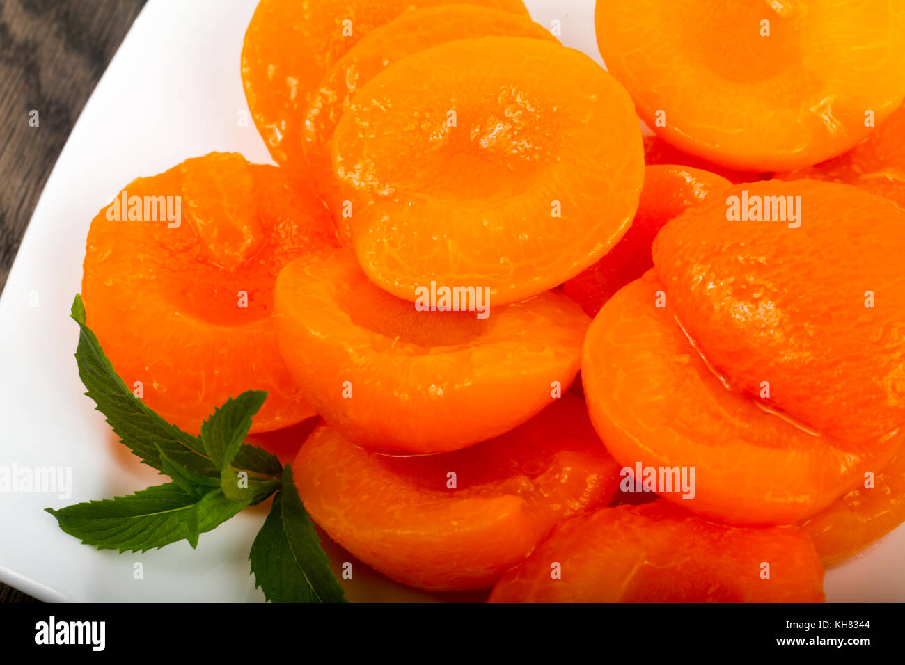 Canned apricots with mint leaves Stock Photo - Alamy
