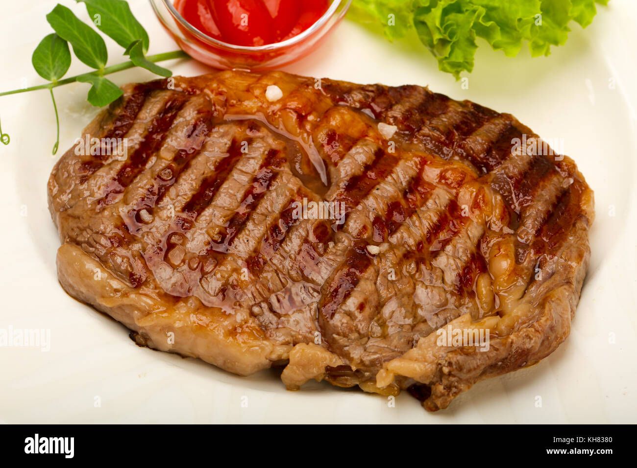 Grilled Rib eye steak with sauce Stock Photo - Alamy