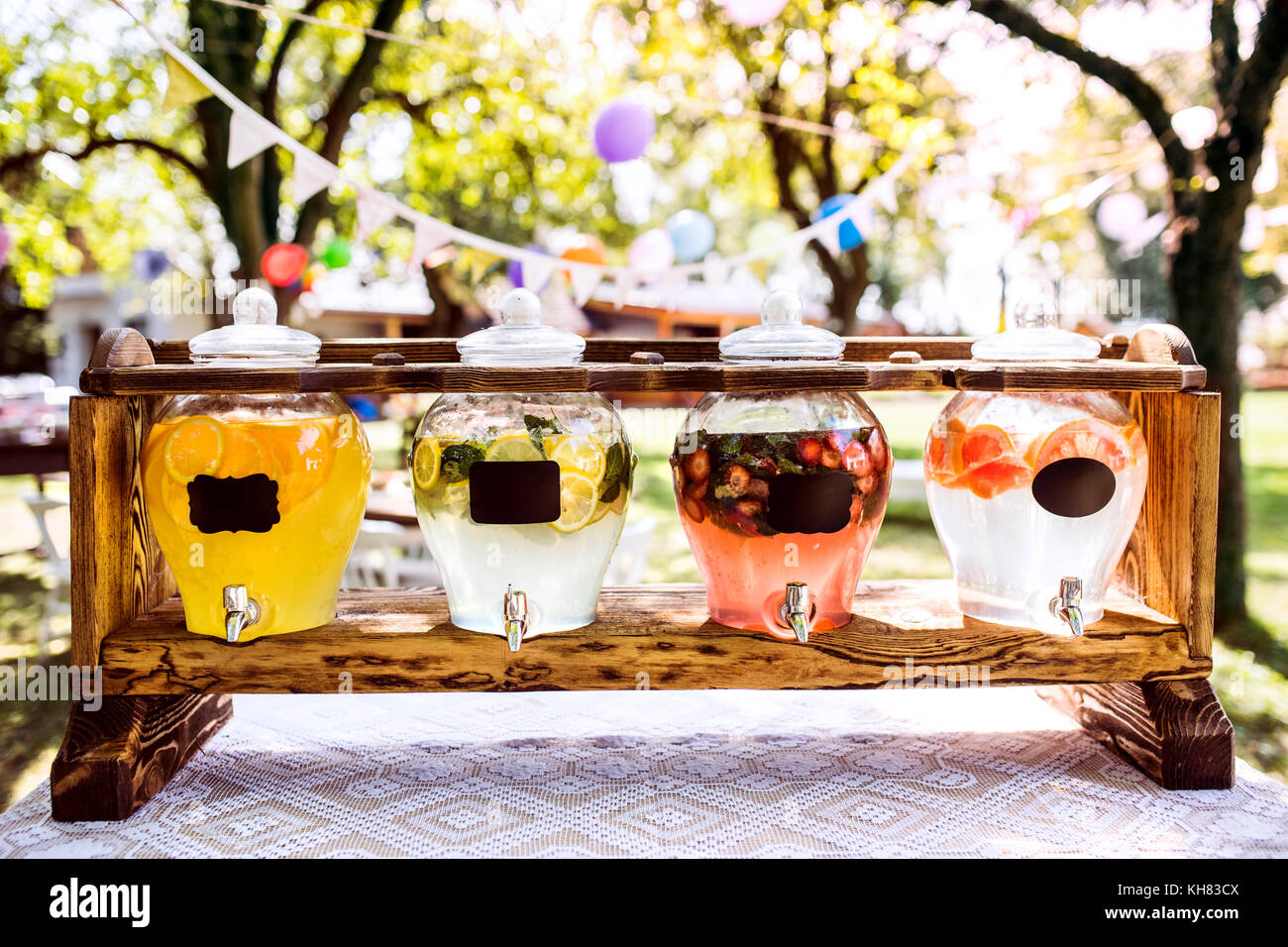 Jars with a tap on a wooden stand in a garden Stock Photo - Alamy
