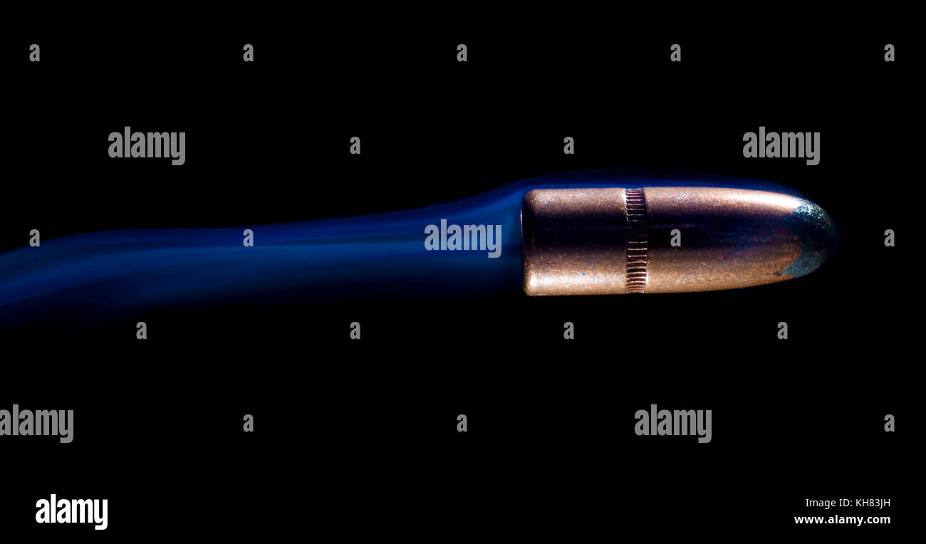 Copper plated bullet on a black background with smoke Stock Photo - Alamy