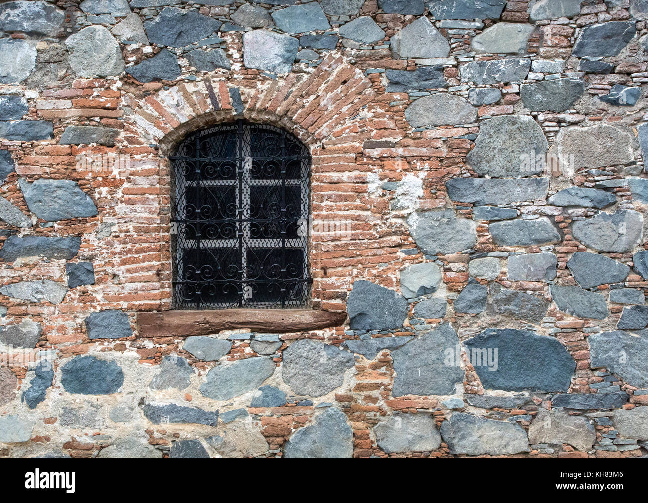 Arch window in old stone wall of medieval castle, horizontal image with ...