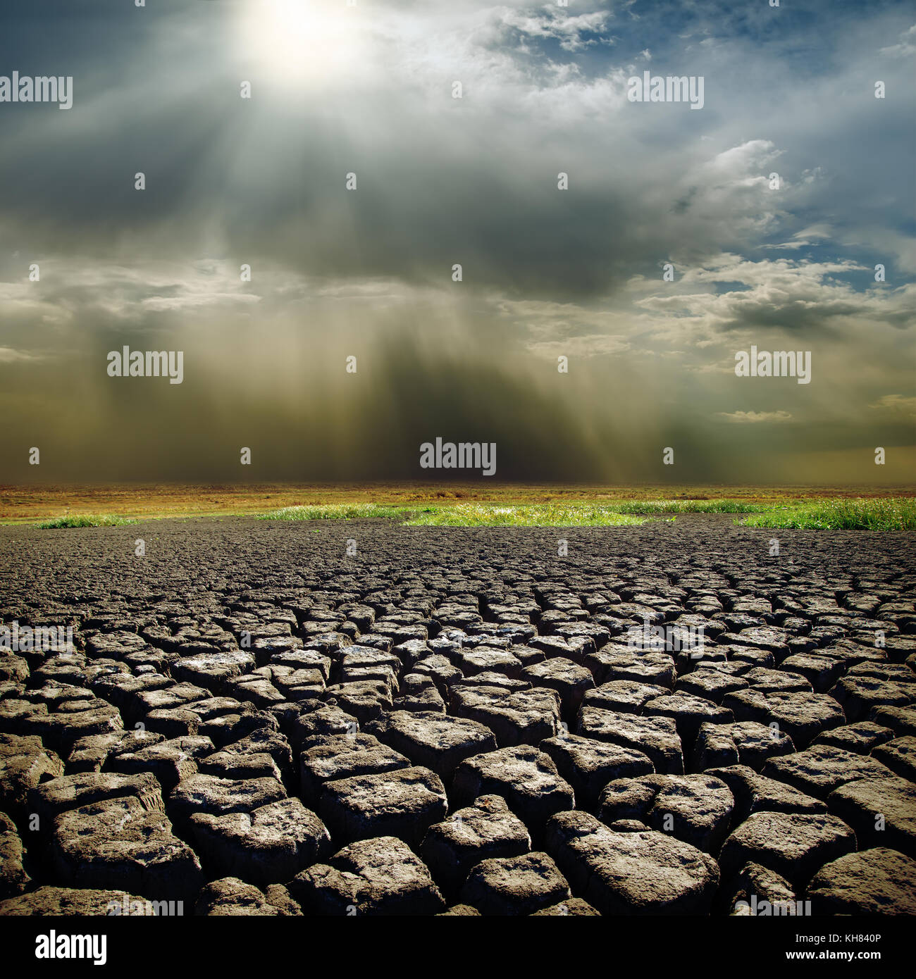 dramatic sky with sun over drought earth Stock Photo - Alamy