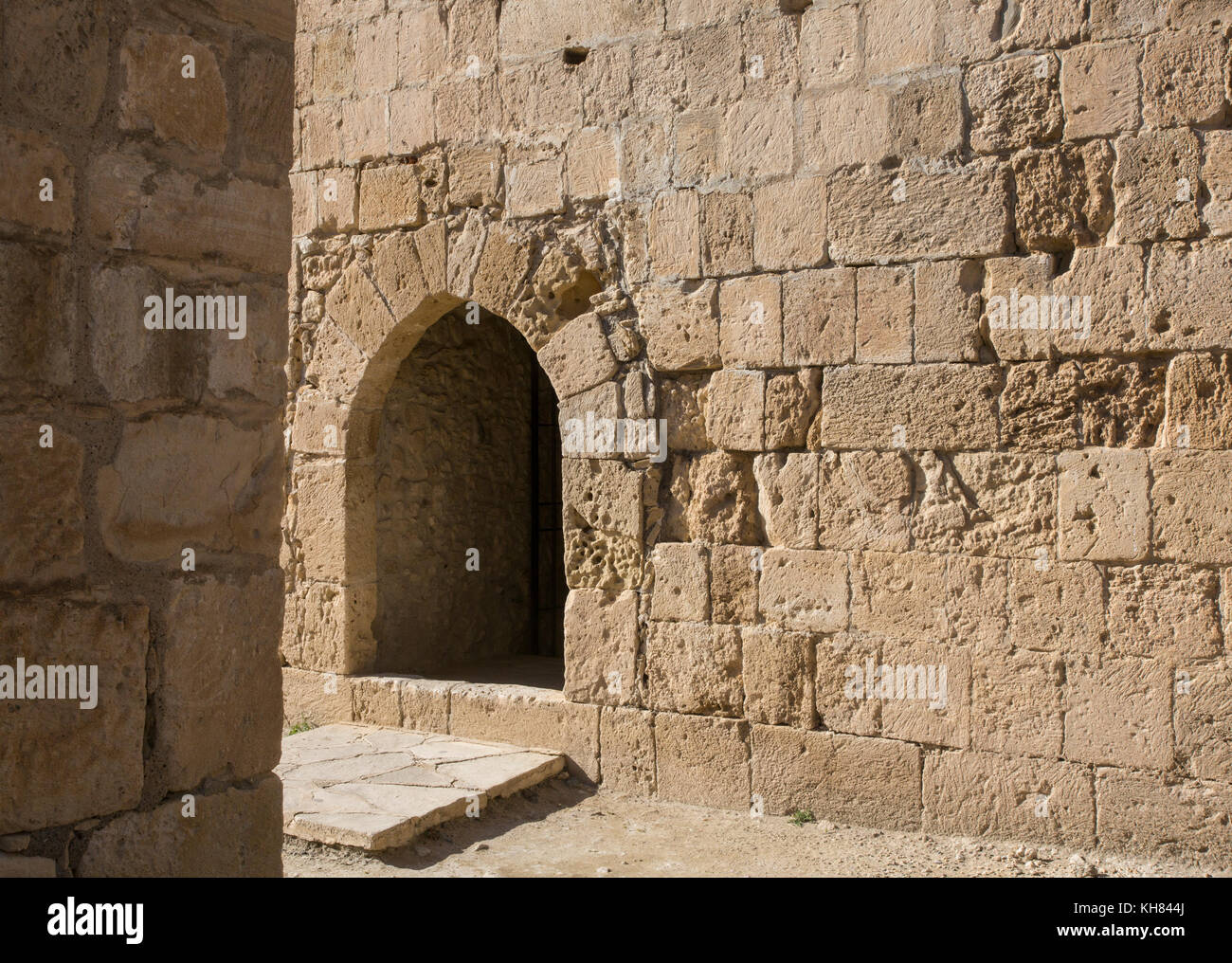 Arch window in old stone wall of medieval castle, horizontal image with ...