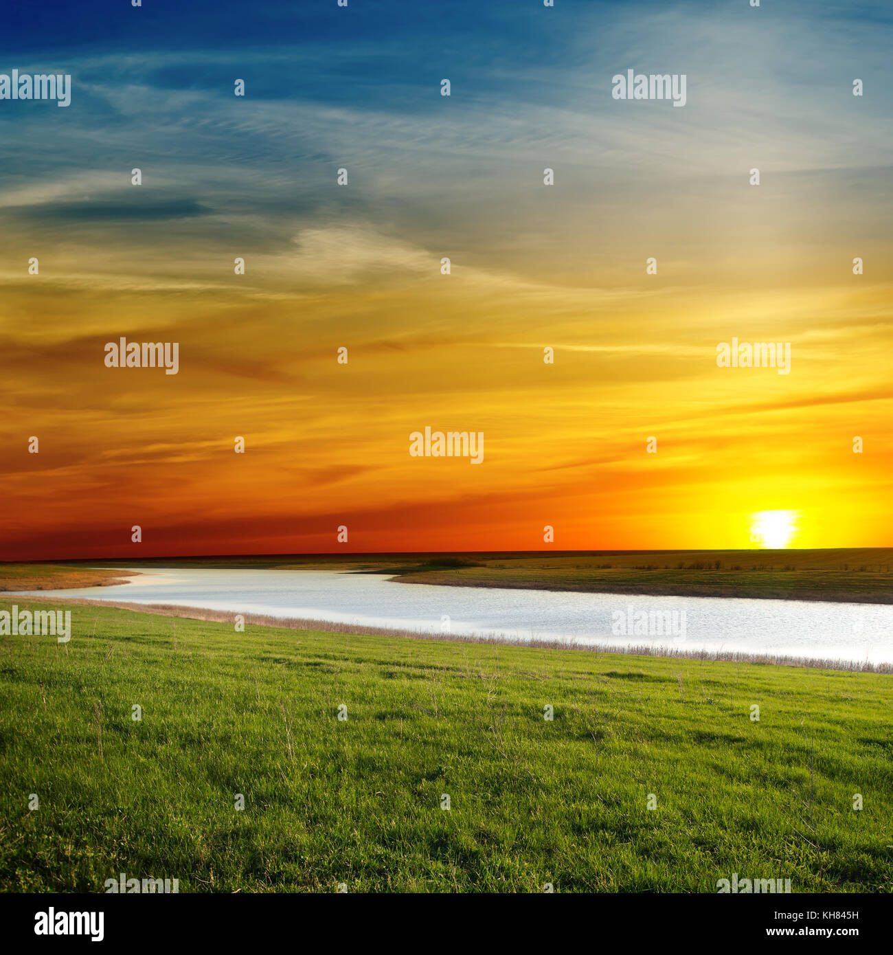 sunset over river Stock Photo - Alamy