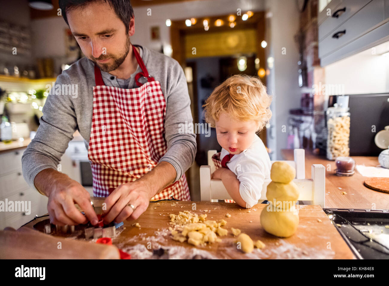 Young family making cookies at home Stock Photo - Alamy