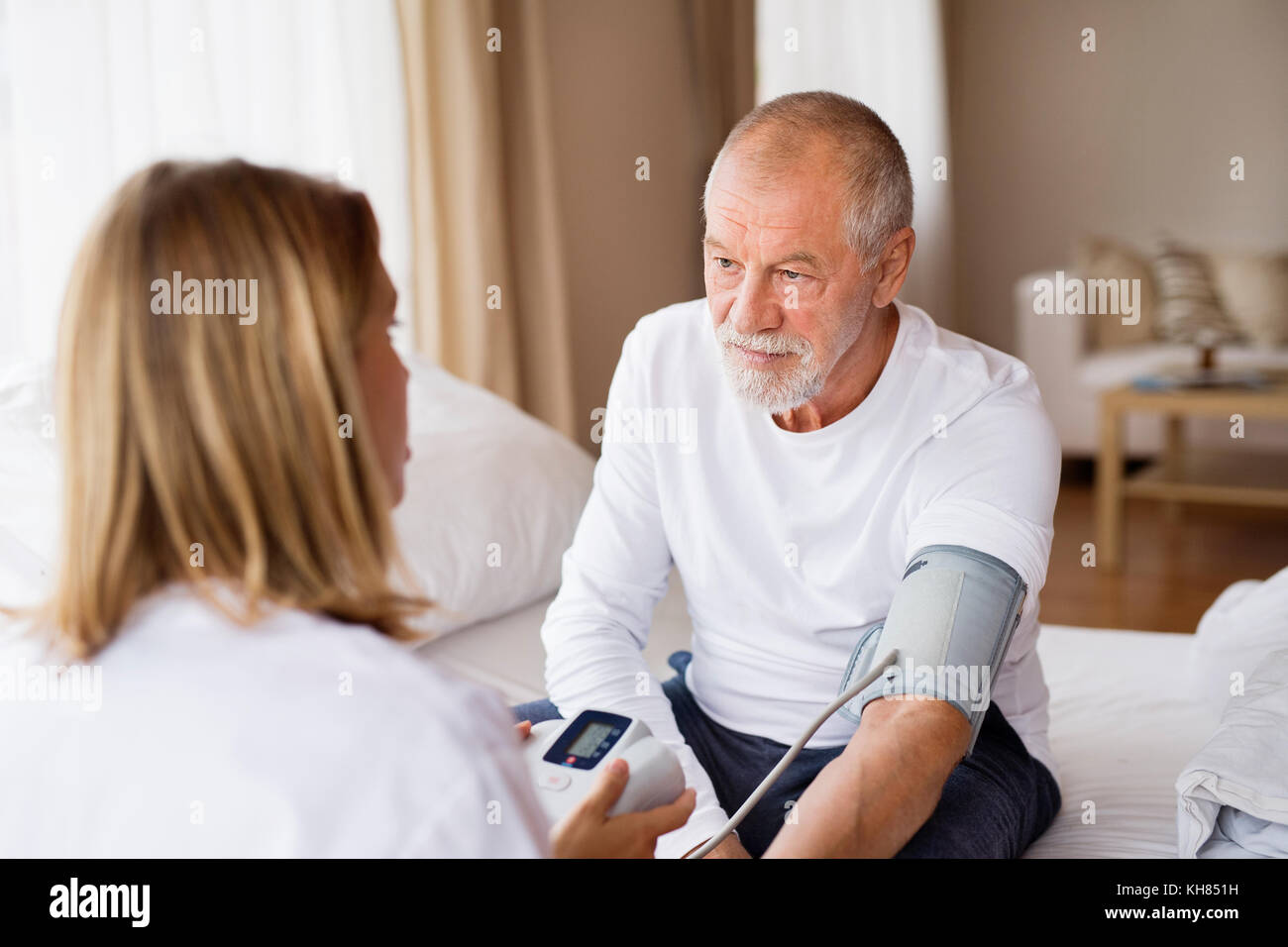 Health visitor and a senior man during home visit Stock Photo - Alamy