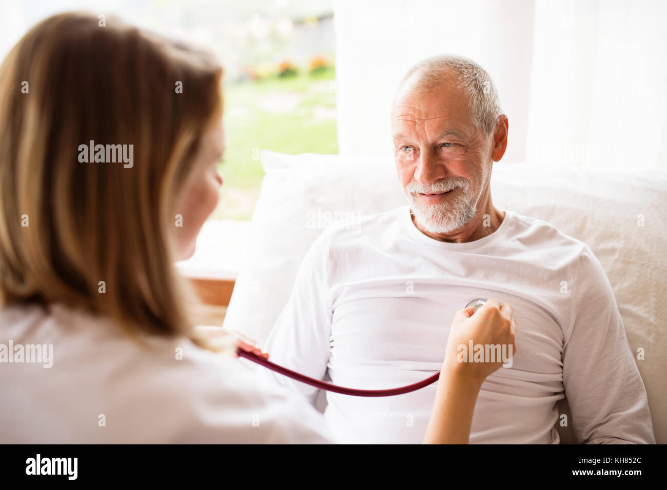 Health visitor and a senior man during home visit Stock Photo - Alamy